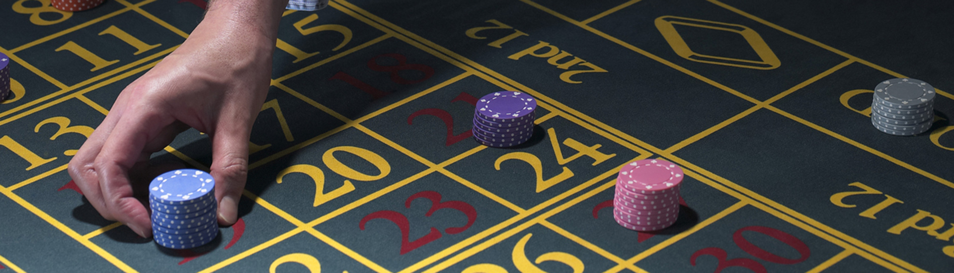 Man placing chips on number at roulette table – HRM Asia